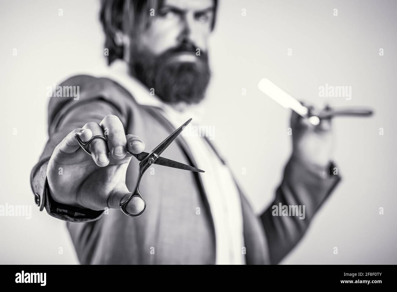 Brutal guy, scissors, straight razor. Barber scissors and straight ...