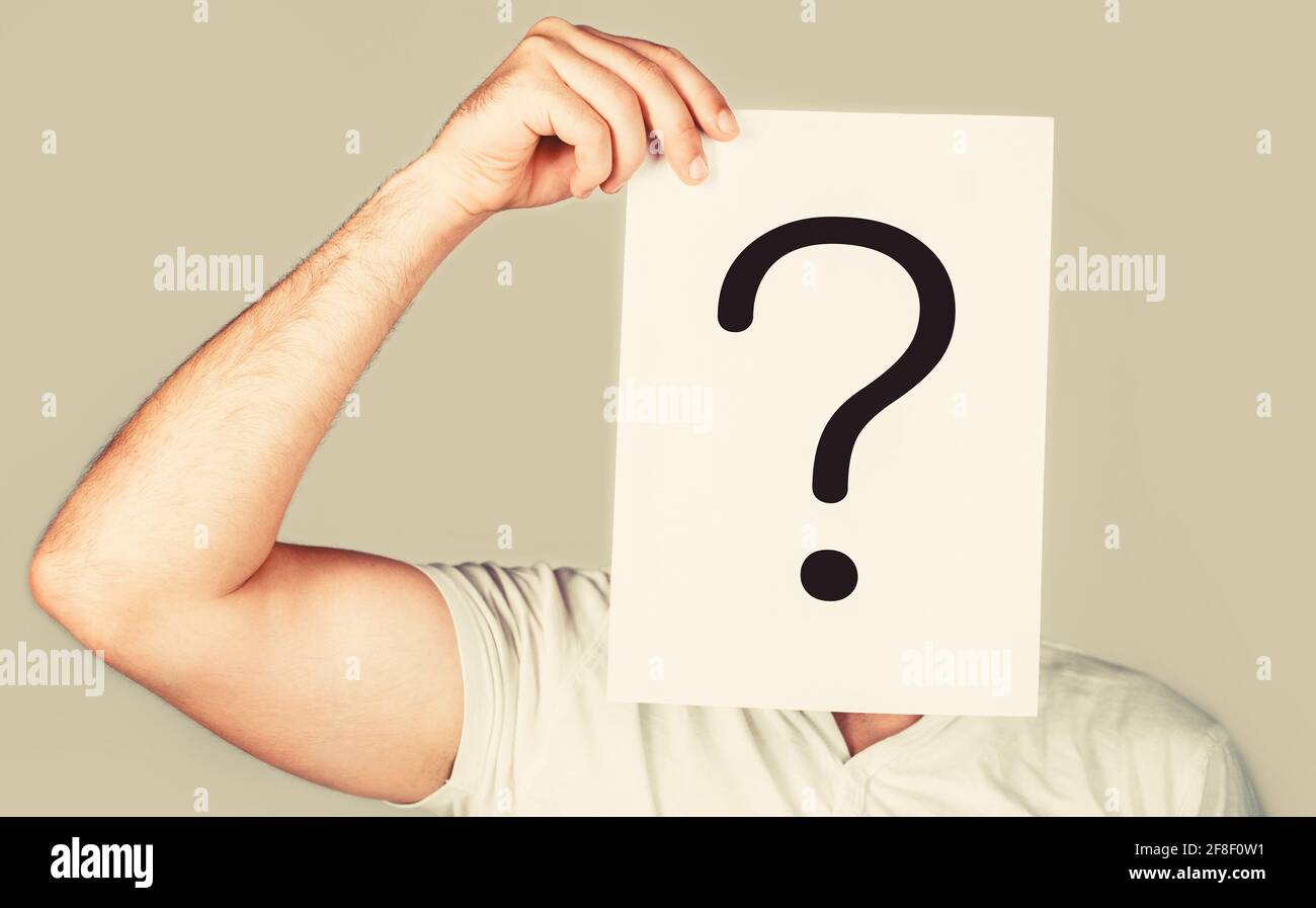 Man a question. Doubtful man holding Question Mark. Problems and ...