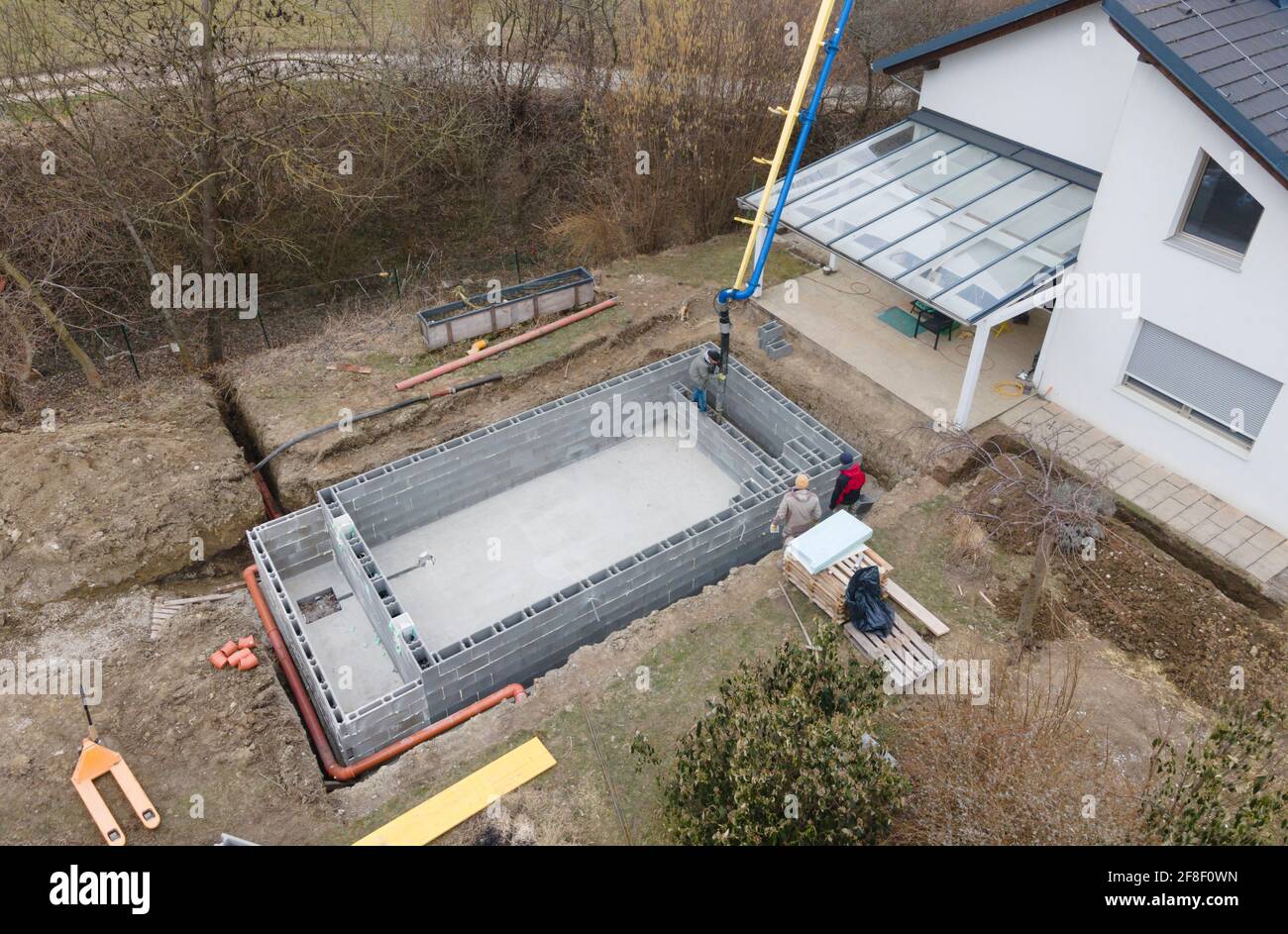 aerial drone shot of pool construction site, form blocks being filled ...