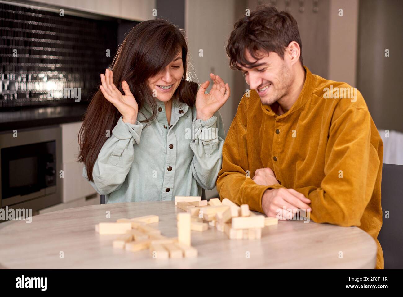 jenga blocks about fall - people play Jenga at home. Family hanging out ...