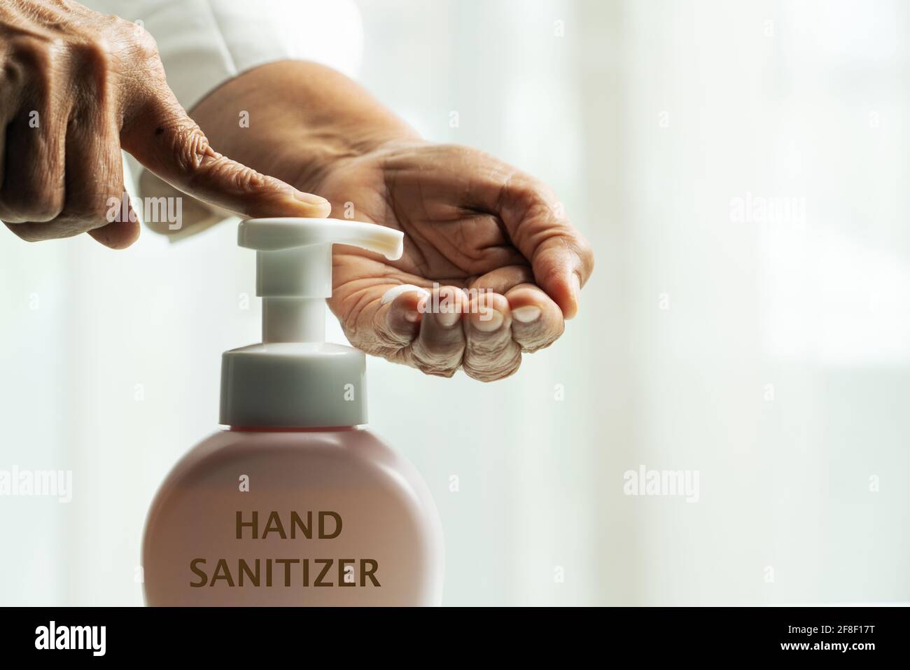 Hand sanitizer foam, hand cleansing concept, senior hand apply alcohol ...