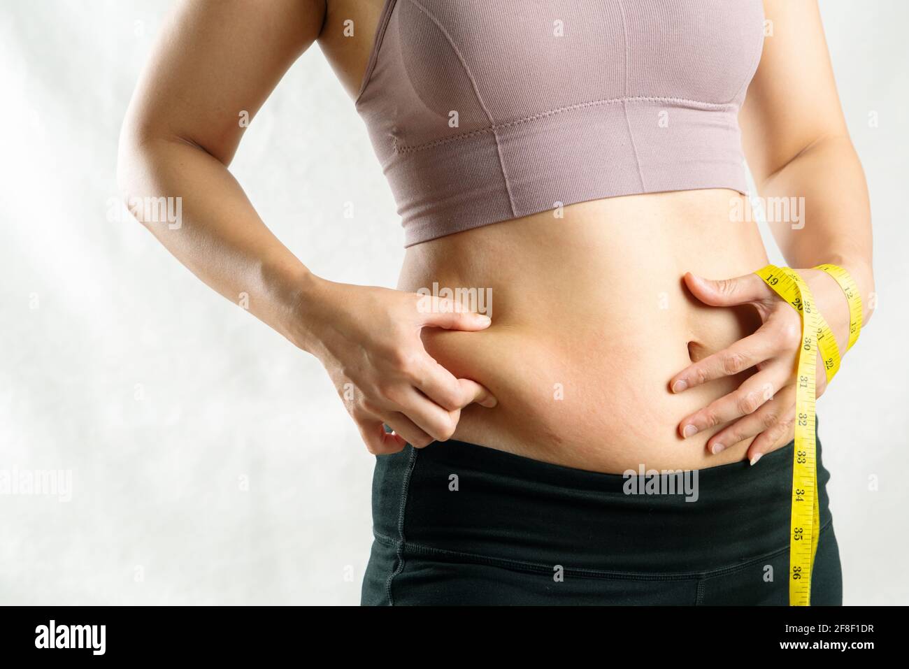 fat woman, fat belly, chubby, obese woman hand holding excessive belly ...