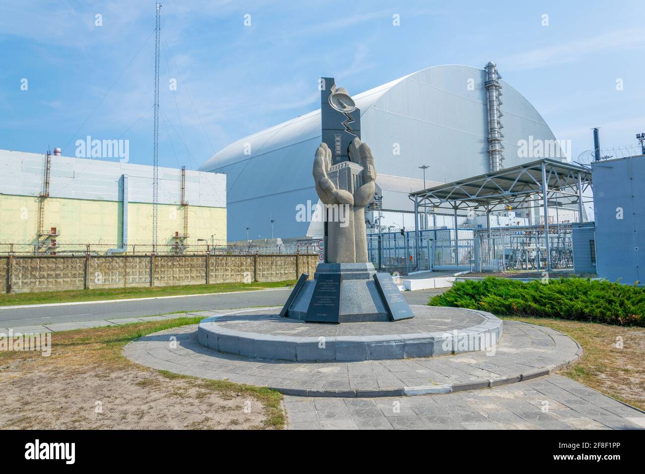 Containment area of Chernobyl power plant viewed behind a memorial in ...