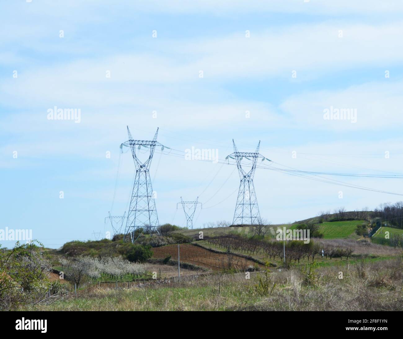High metal structure with high voltage transmission cables and a blue ...