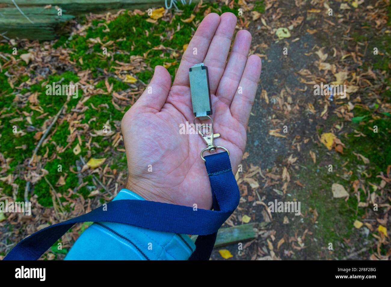 Male hand is holding a radiation absorbtion badge in the Chernobyl ...
