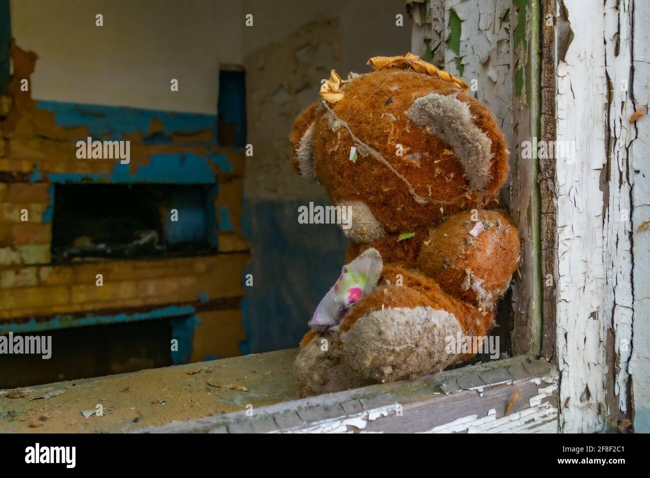 Plush teddy bear toy at a window of a house inside of the Chernobyl ...