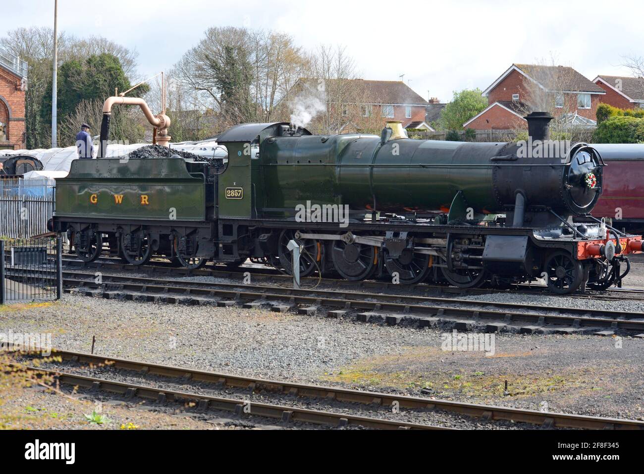 Steam train driver fills ex Great Western locomotive 2857 with water at ...