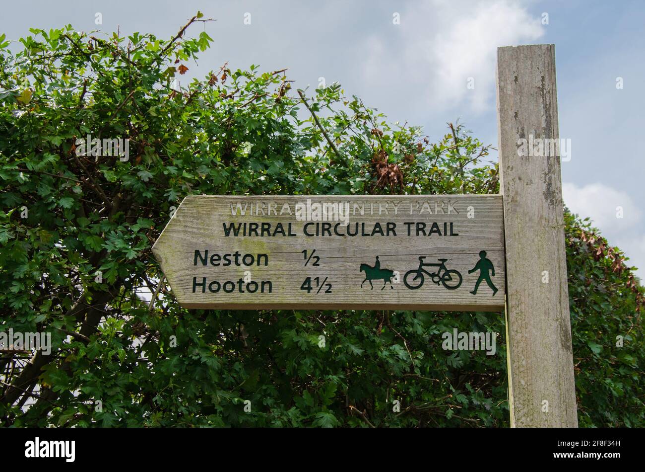 Wooden sign in Wirral Country Park indicating a foot path, bridleway ...
