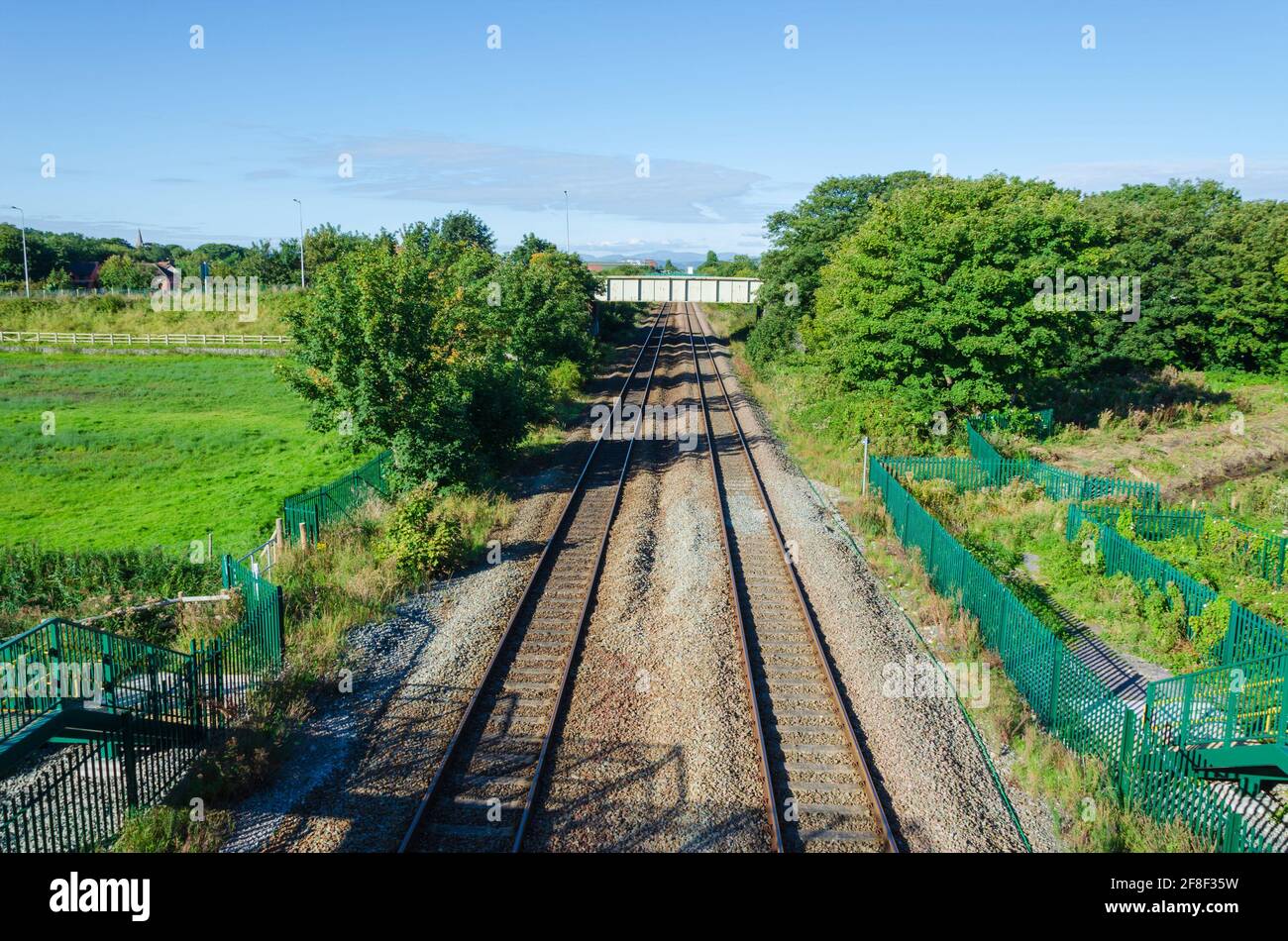 A two line section of railway track with a metal road bridge, seen from ...