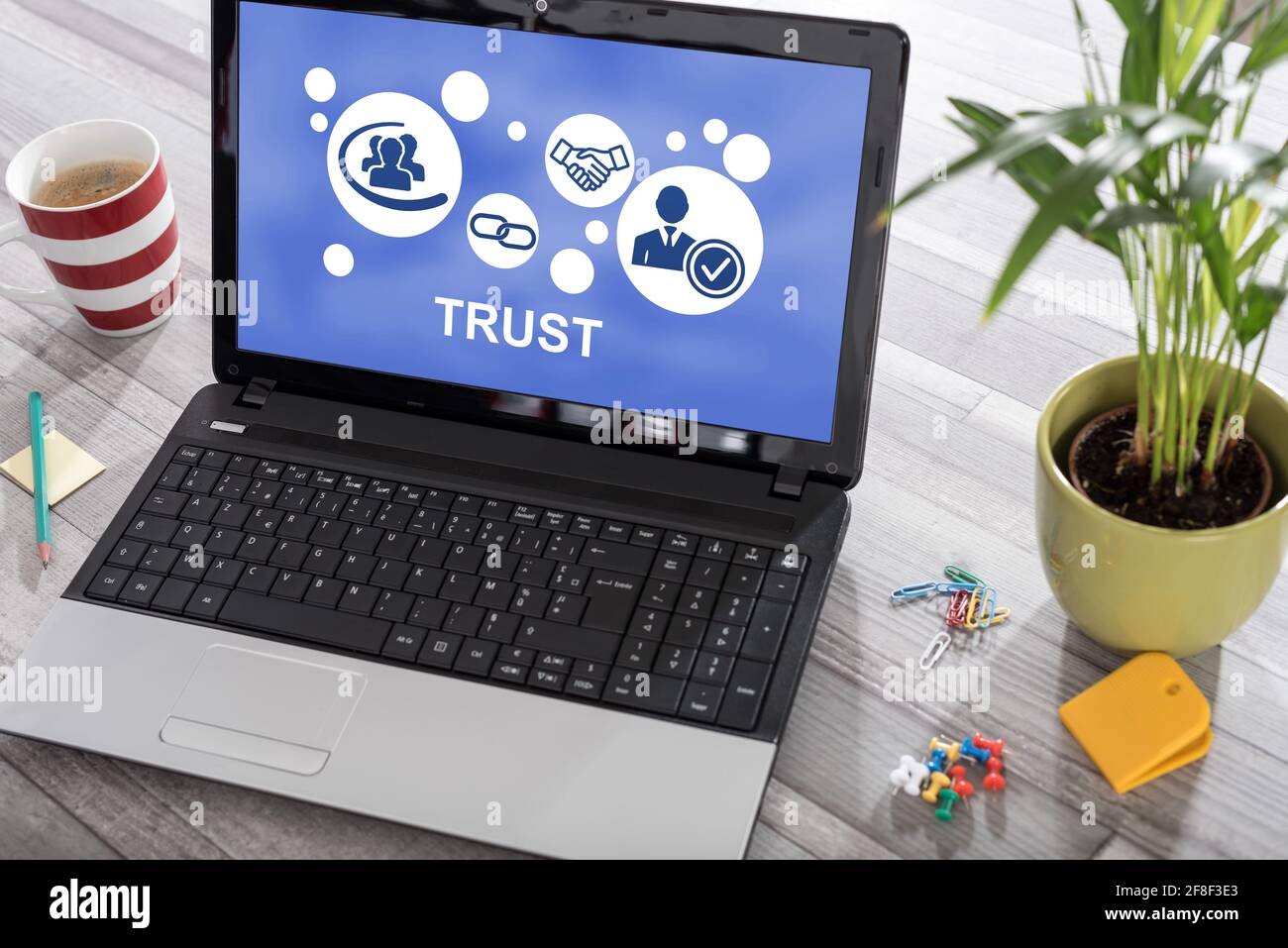 Laptop on a desk with trust concept on the screen Stock Photo - Alamy