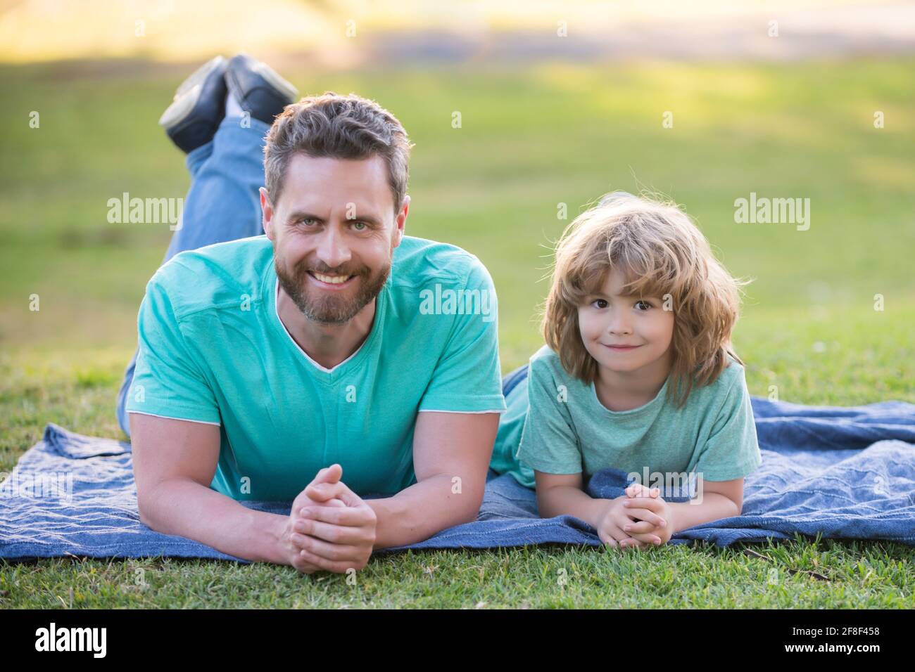Father and son relaxing on nature in park. Concept of children and ...
