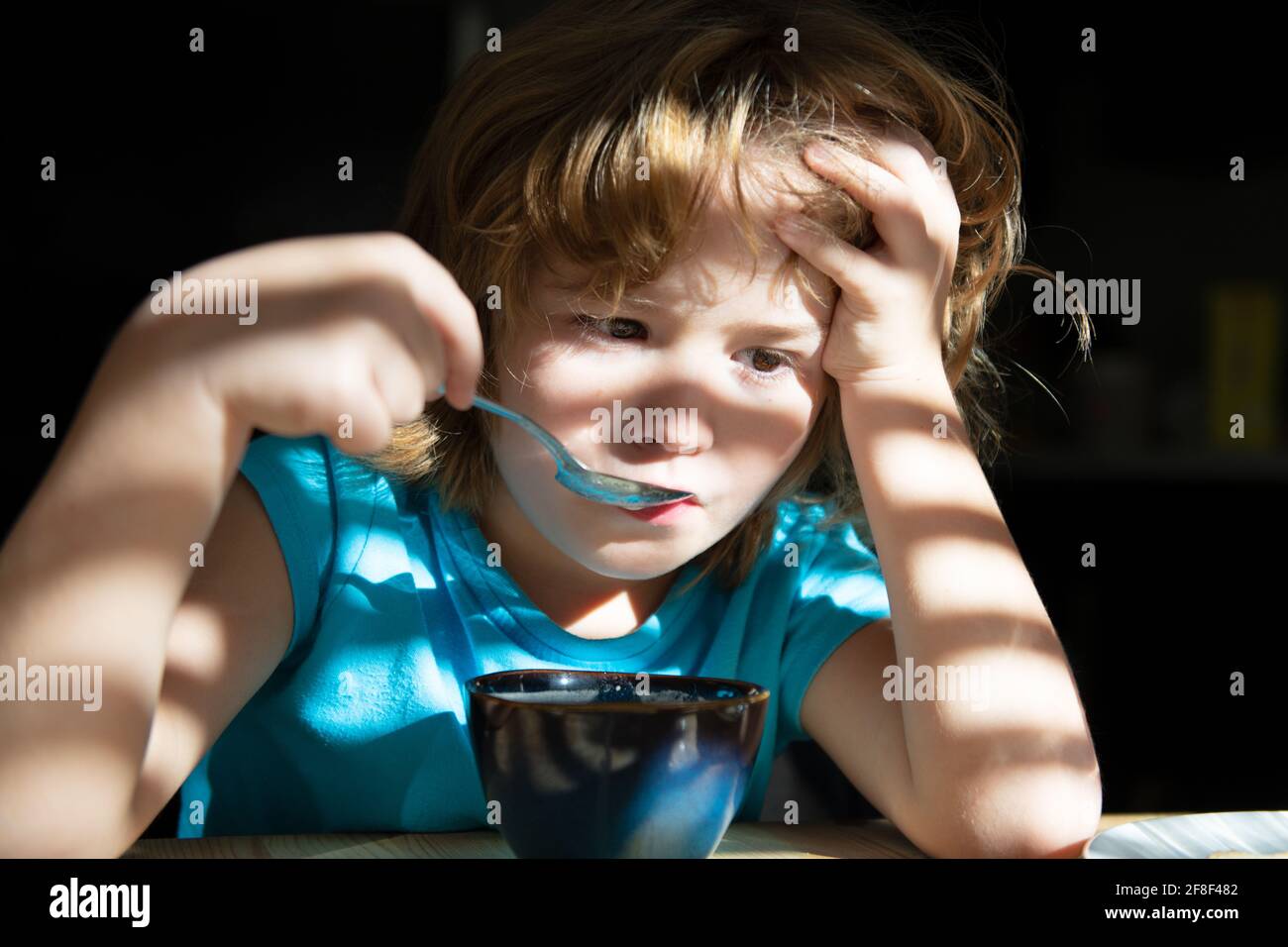 Nutrition for kids. Home food. Boy eats breakfast at kitchen Stock ...