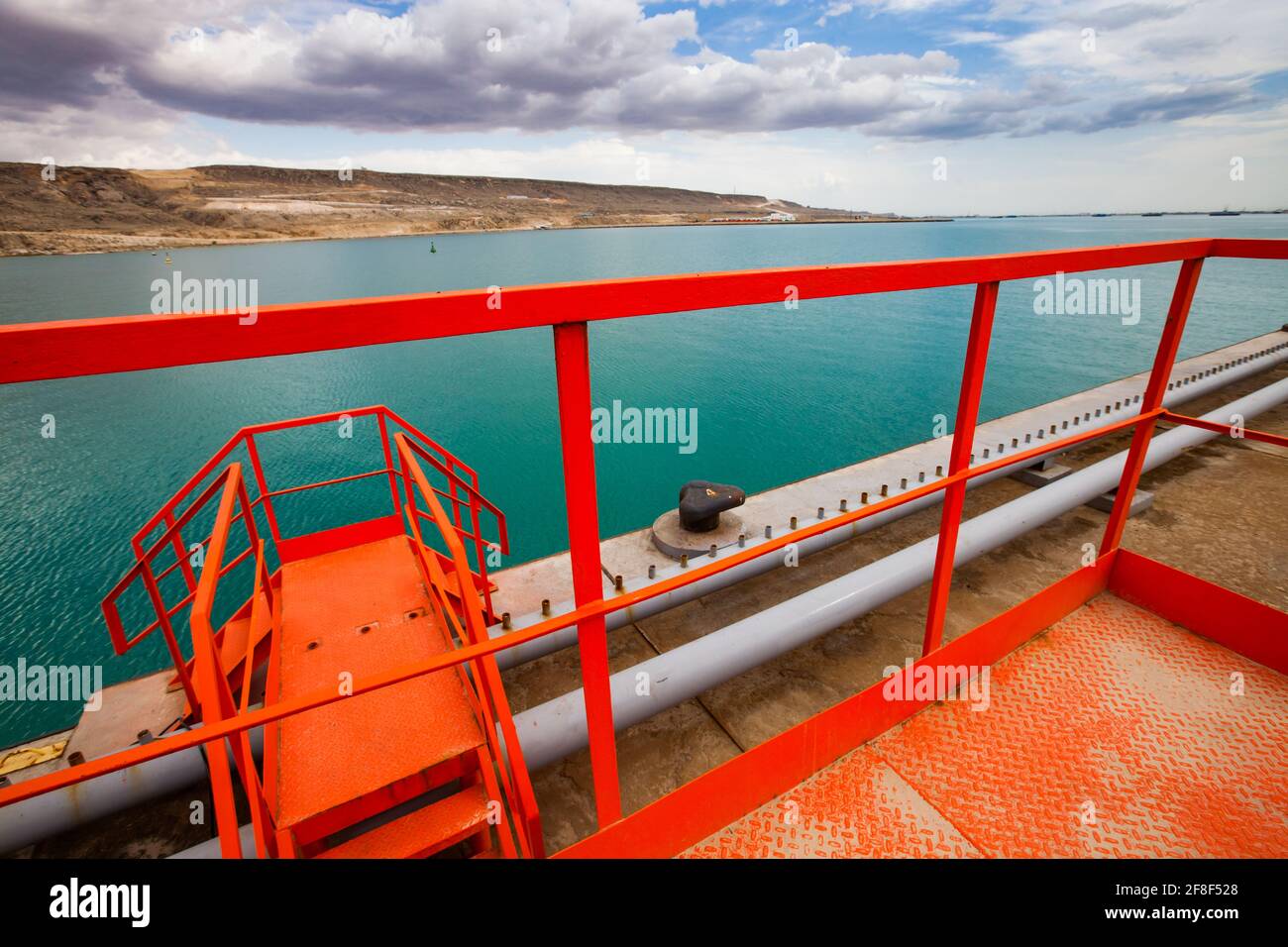 Close-up of oil loading terminal for oil tanker ships. Orange stairs ...