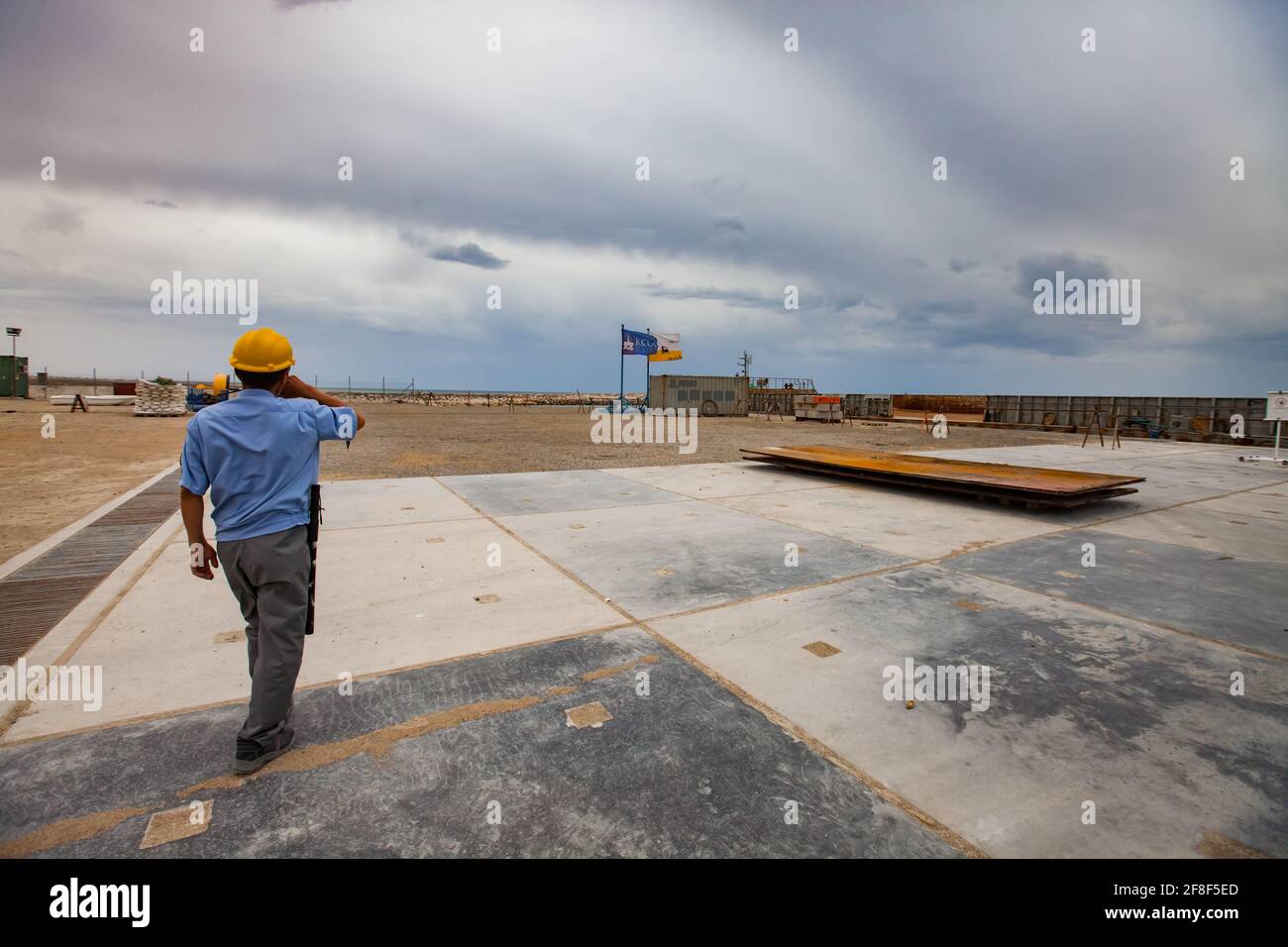 View on empty seaport. Loading terminal. Security guard in yellow hard ...