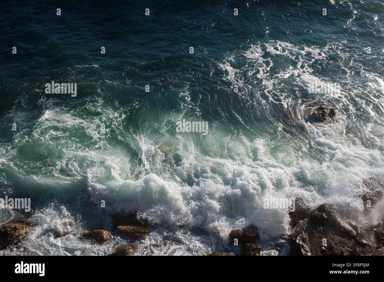 Ocean wave background breaking sea water rocky shore rough seas ...