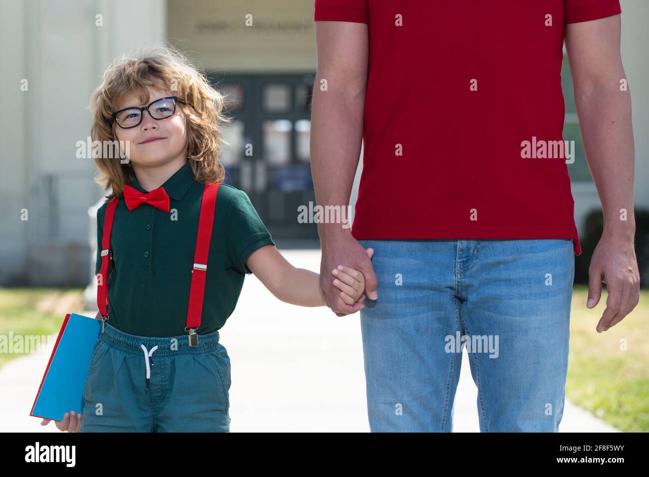 Father walking son to school. Parent and nerd pupil of primary school ...
