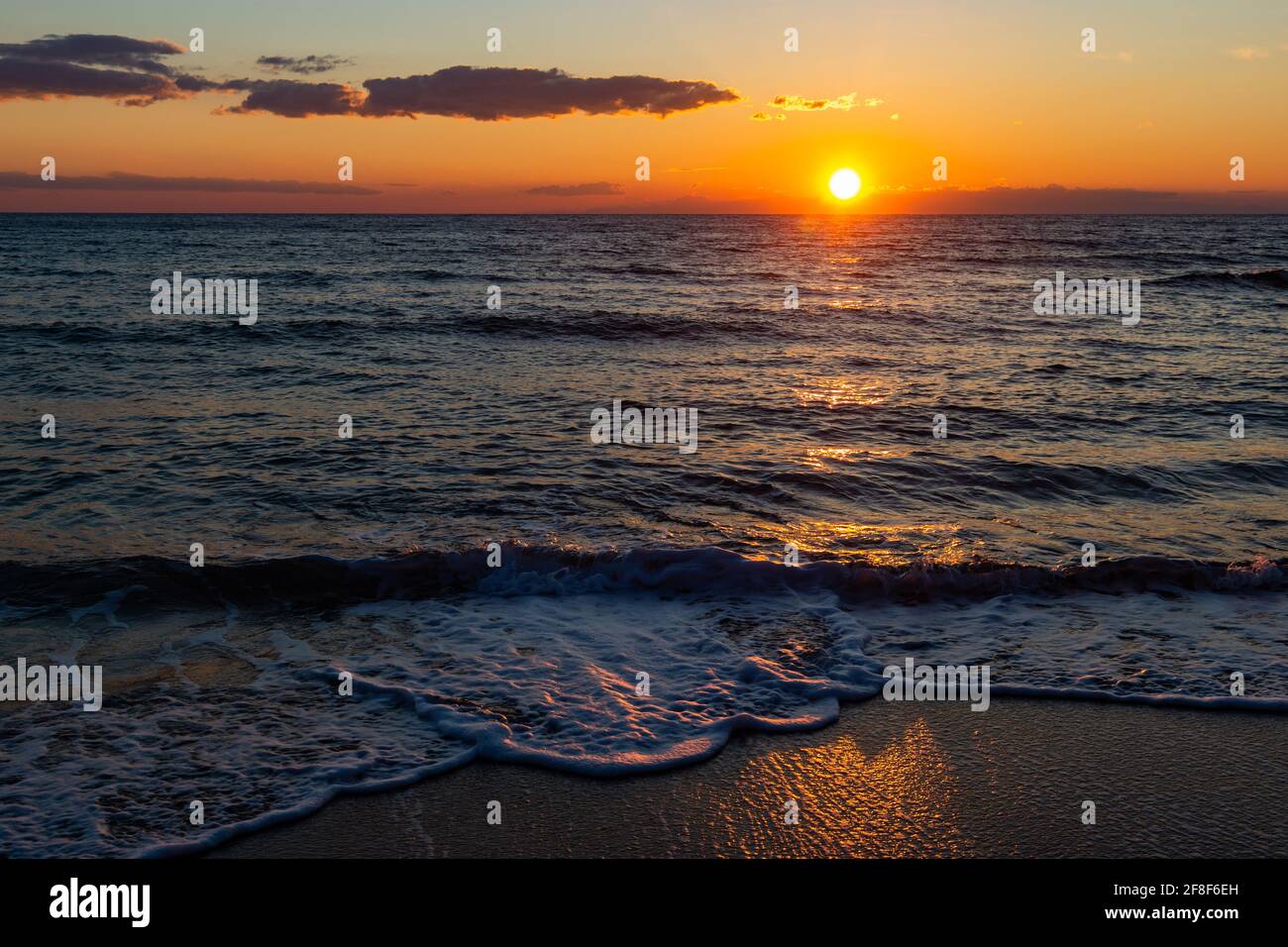 Sunset over the tropical sea Stock Photo - Alamy