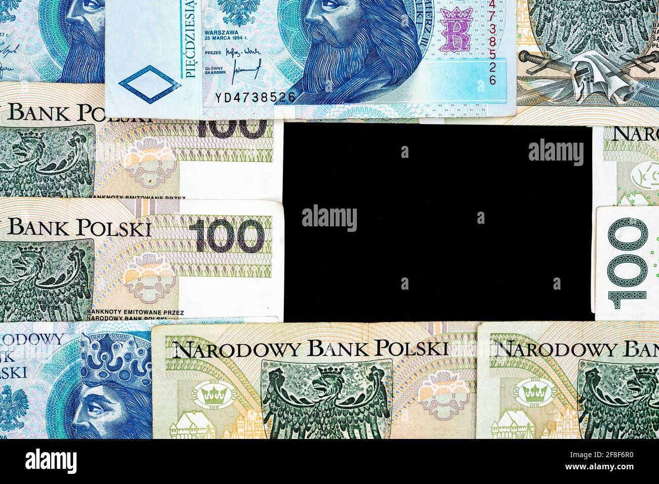 Polish banknotes of PLN 100 and PLN 50 on a black background. Photo ...