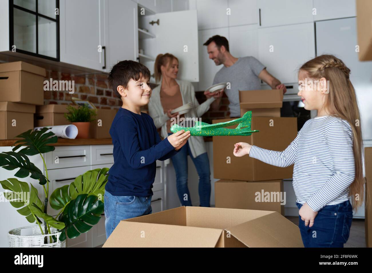 Happy family during moving to a new home Stock Photo - Alamy