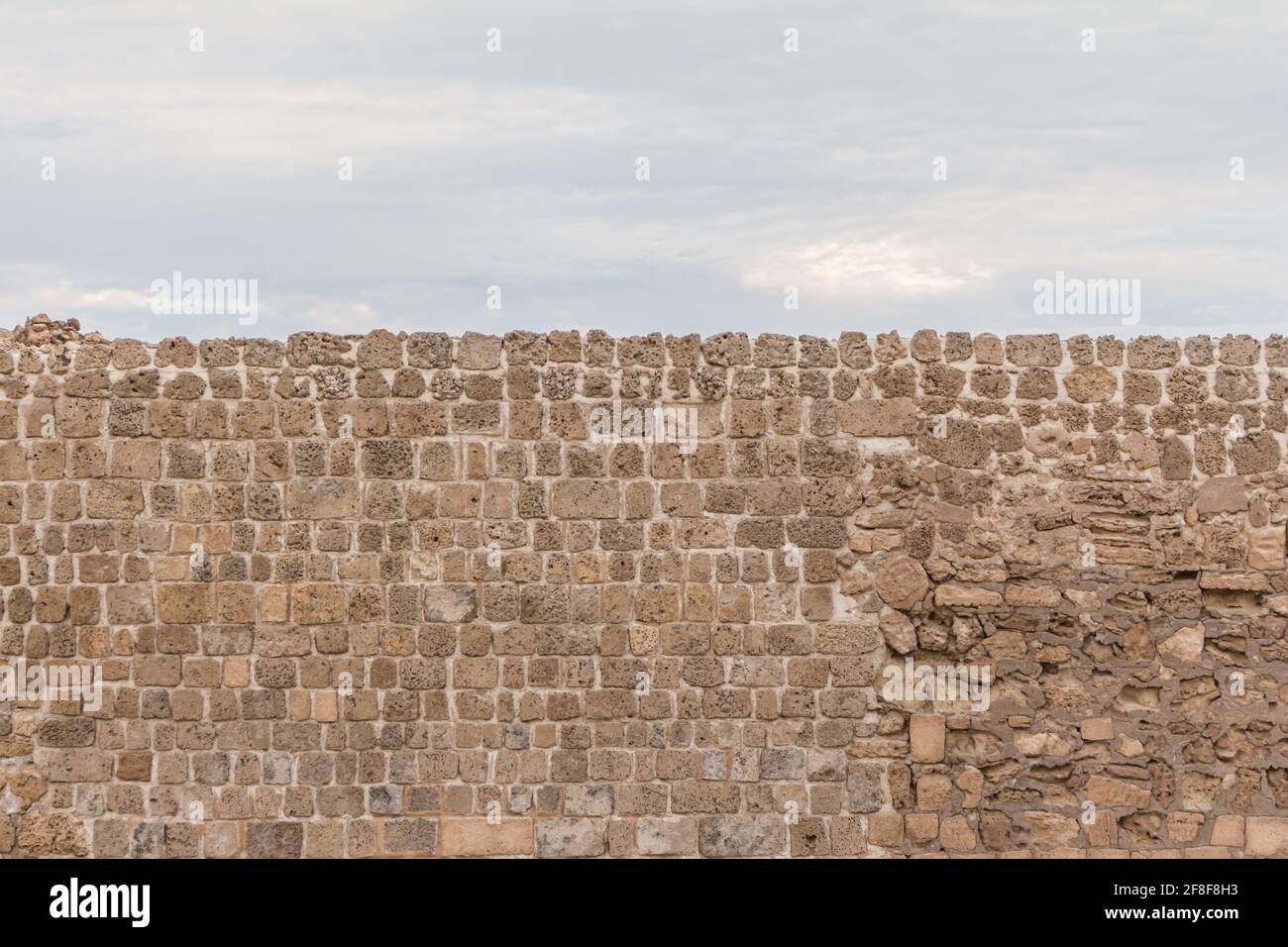 Old stable stone wall with rows of crafted masonry stones. Brickwork ...