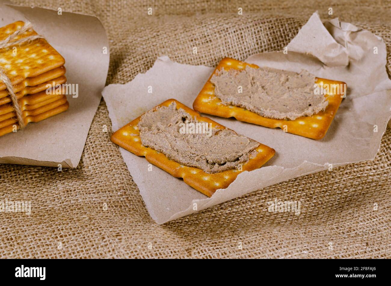 Rectangular liver pate crackers on a burlap sack. Ready-to-eat food on ...