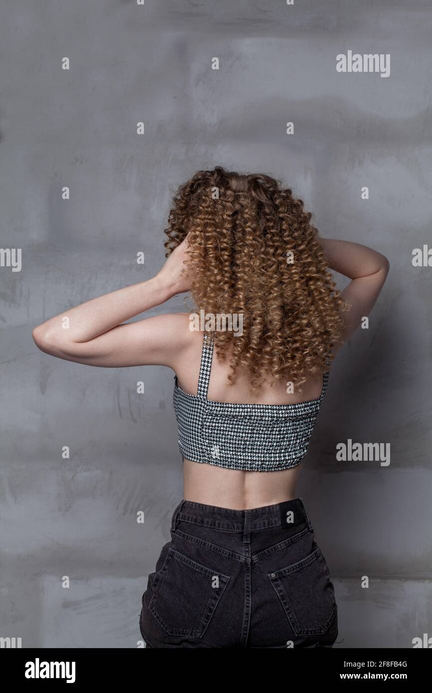 Beautiful woman back head with afro curly hairstyle on gray background ...
