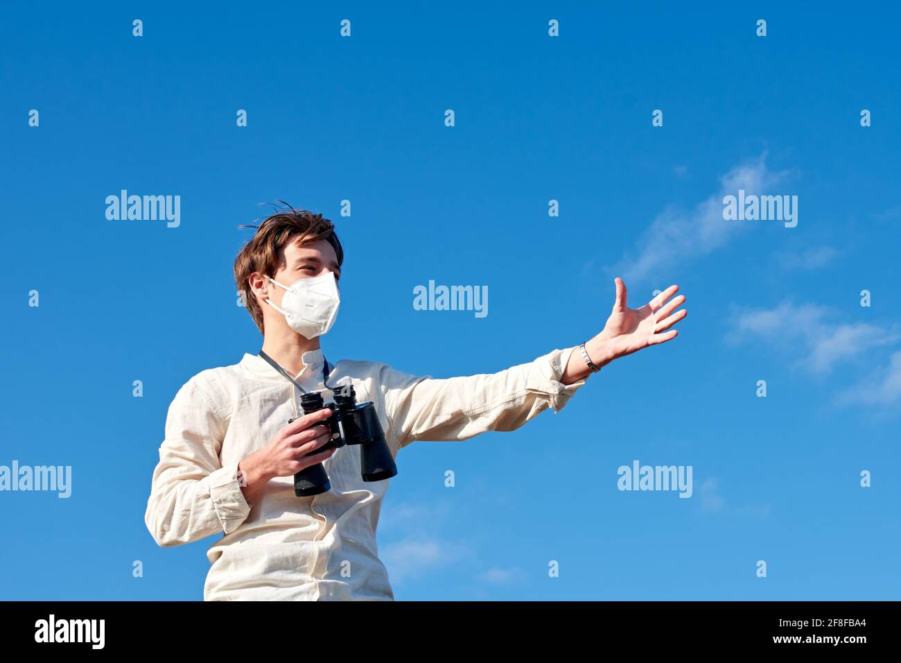 Spanish adventurous male traveler wearing a mask admiring the beautiful ...