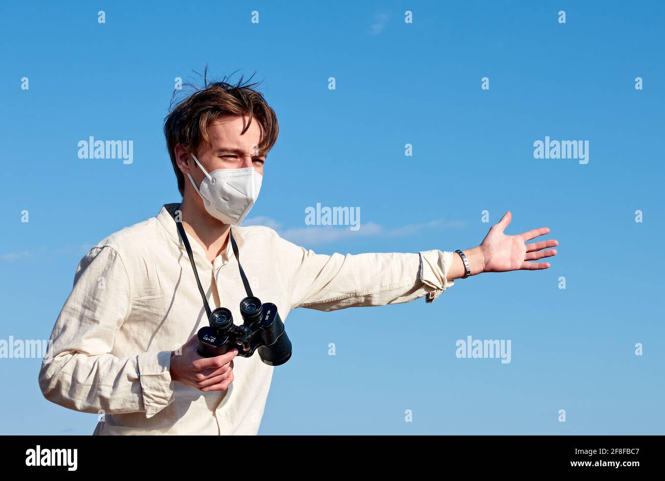 Spanish adventurous male traveler wearing a mask admiring the beautiful ...