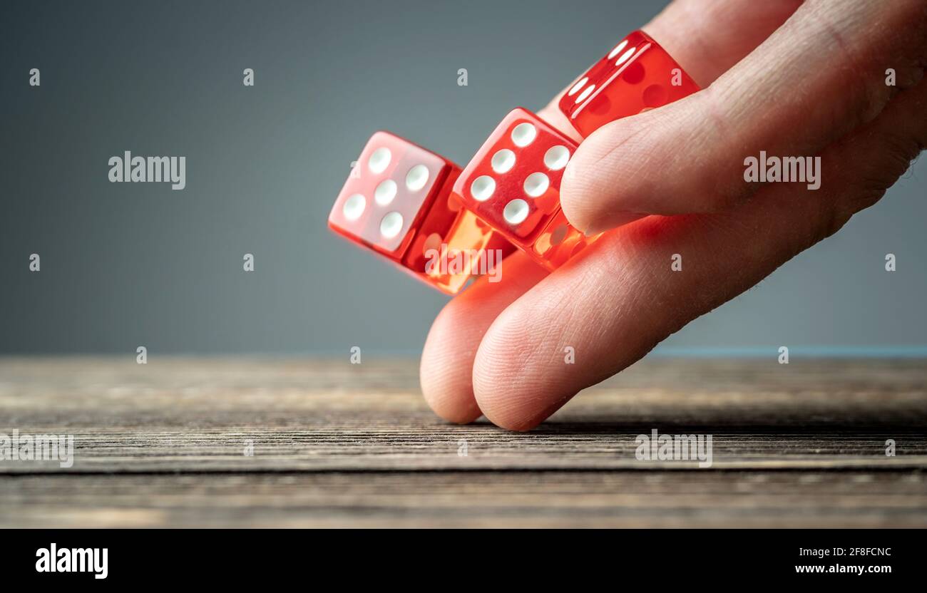 Hand Rolling Dice On Table