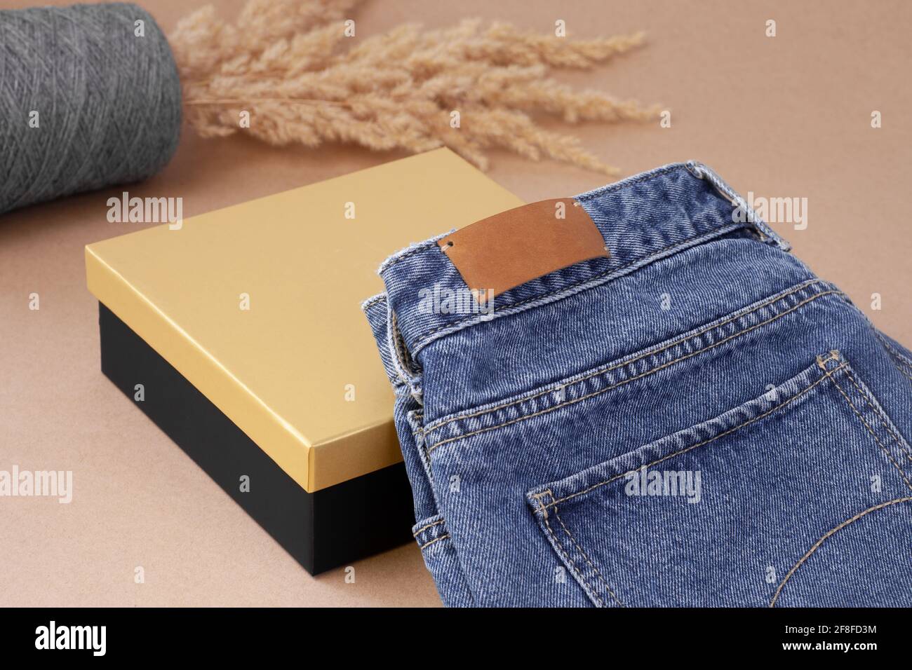 close-up leather empty tag or label on the back pocket of blue jeans on ...