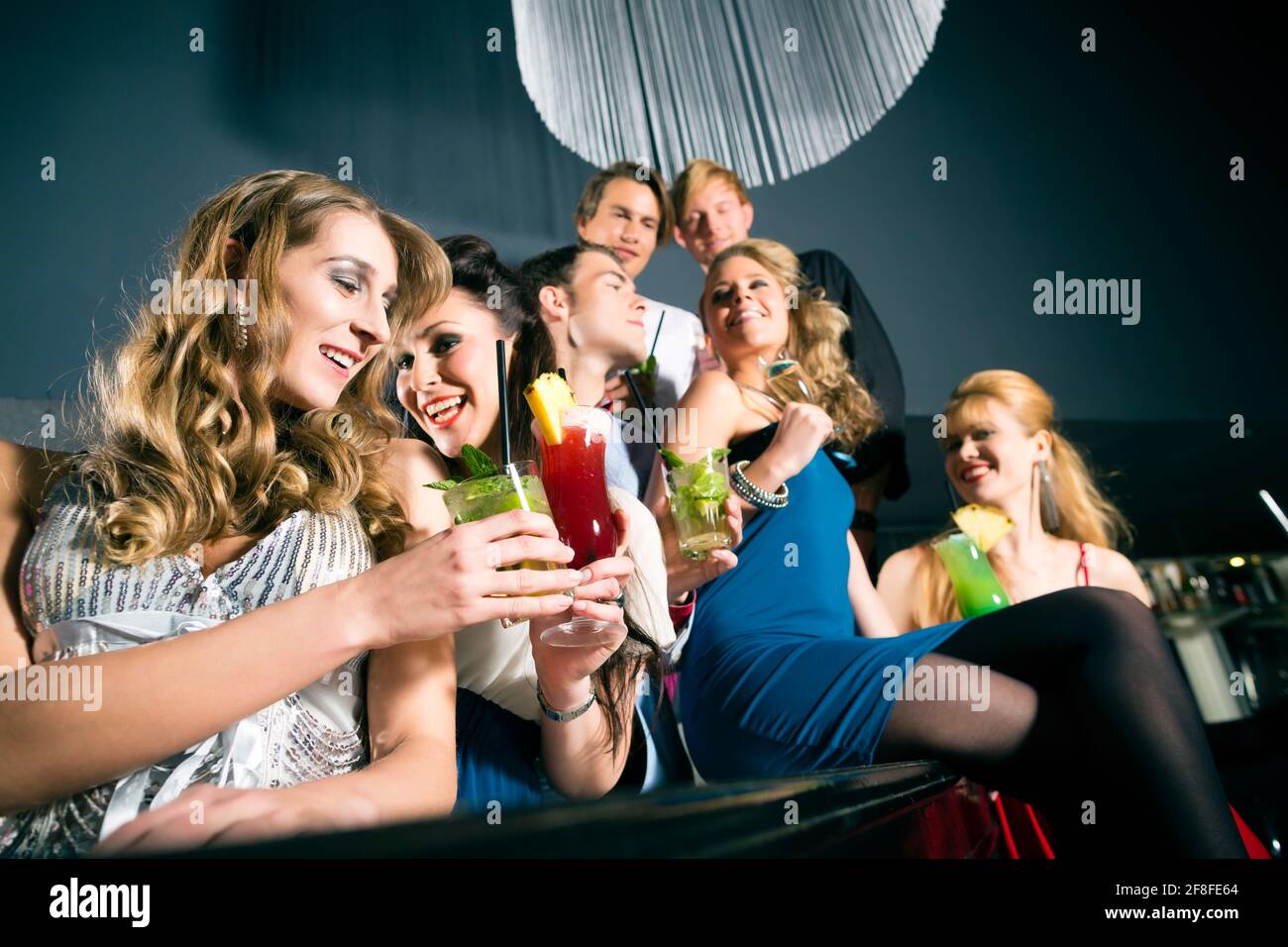 Young people in club or bar drinking cocktails and having fun Stock ...