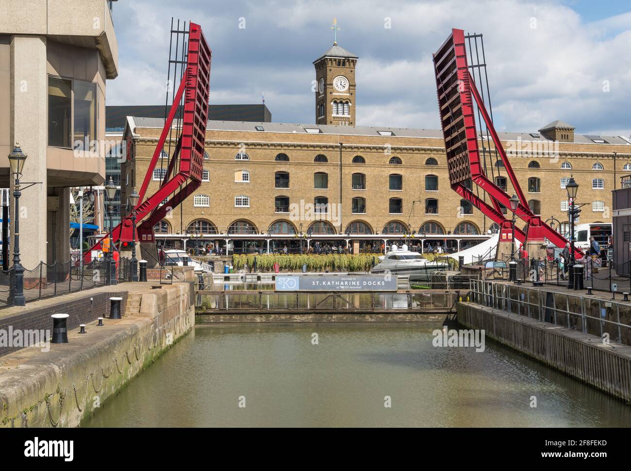The drawbridge being raised at the lock in St Katharine Docks Marina ...