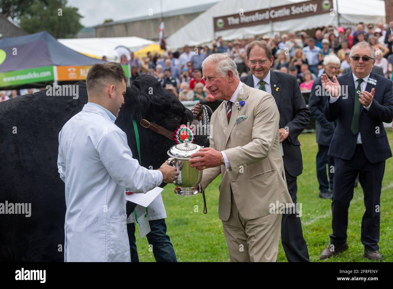 HRH Prince of Wales presenting a trophy to the owners of the champion ...