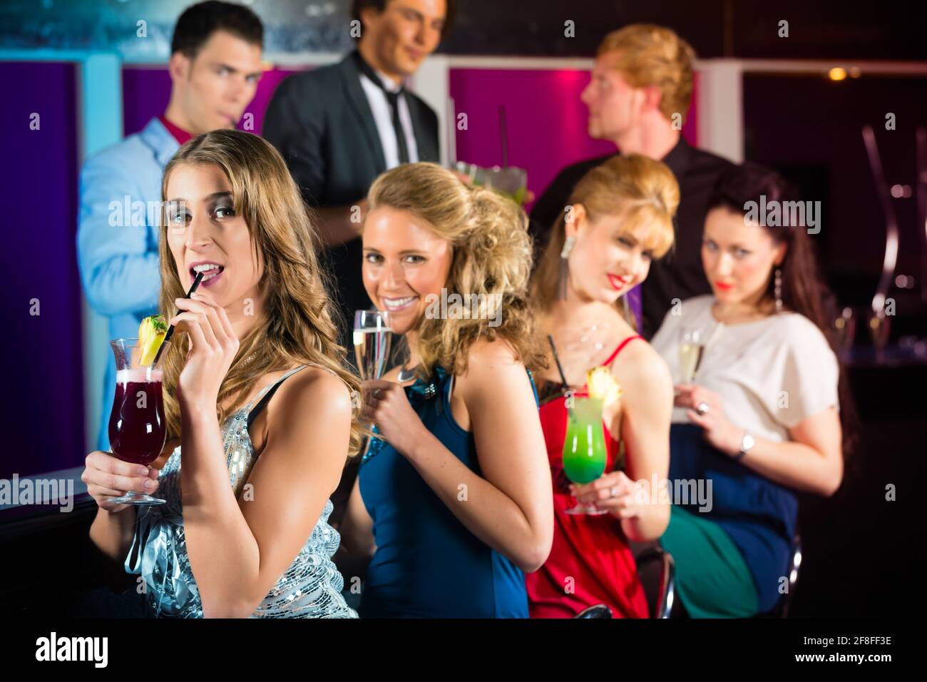 Young people in club or bar drinking cocktails and having fun Stock ...