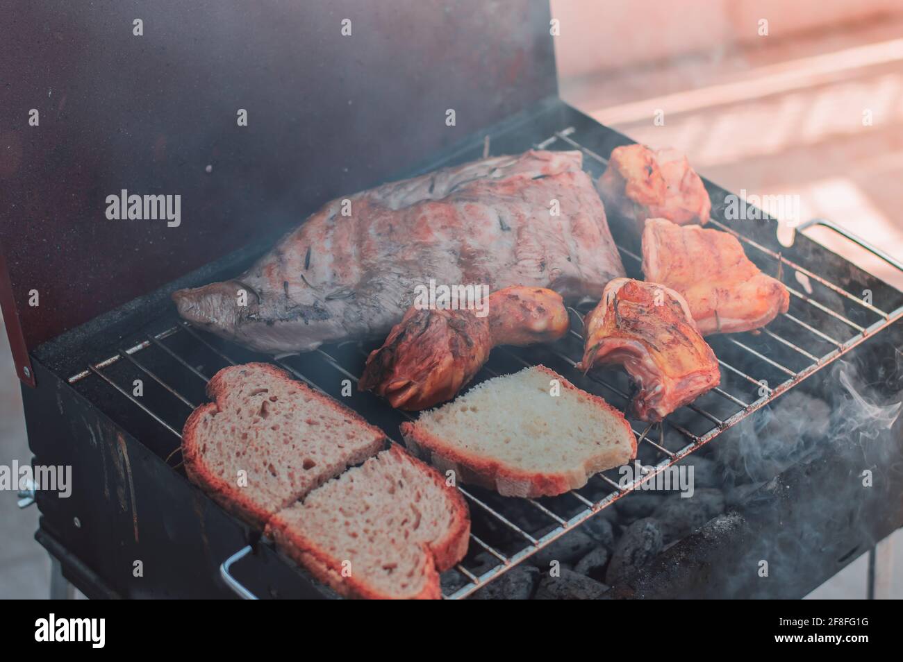 Delicious meat on barbecue grill with steam.Close up.Chicken,beef and bread Stock Photo - Alamy