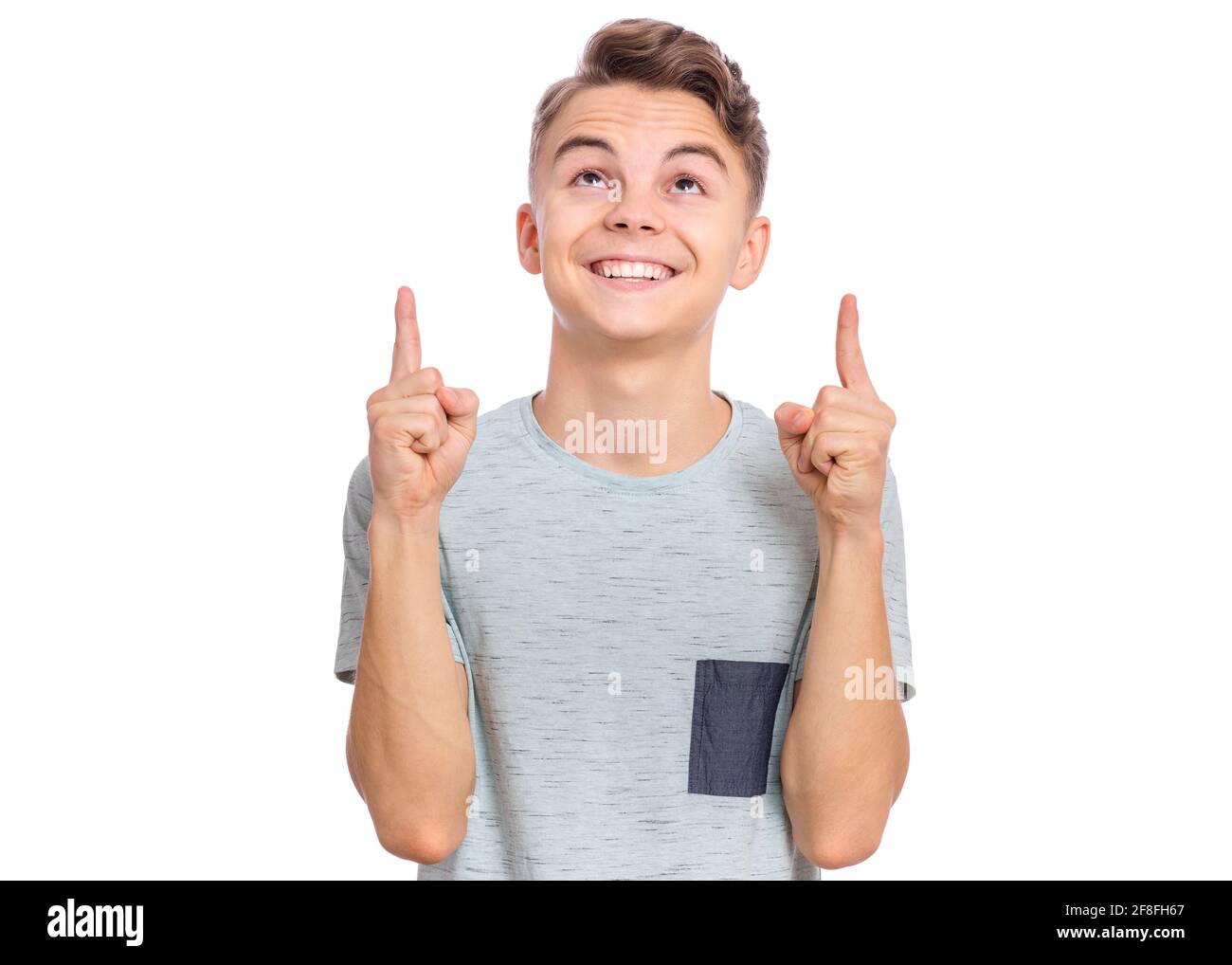 Cute teen boy pointing up, gesturing idea or doing number one gesture ...
