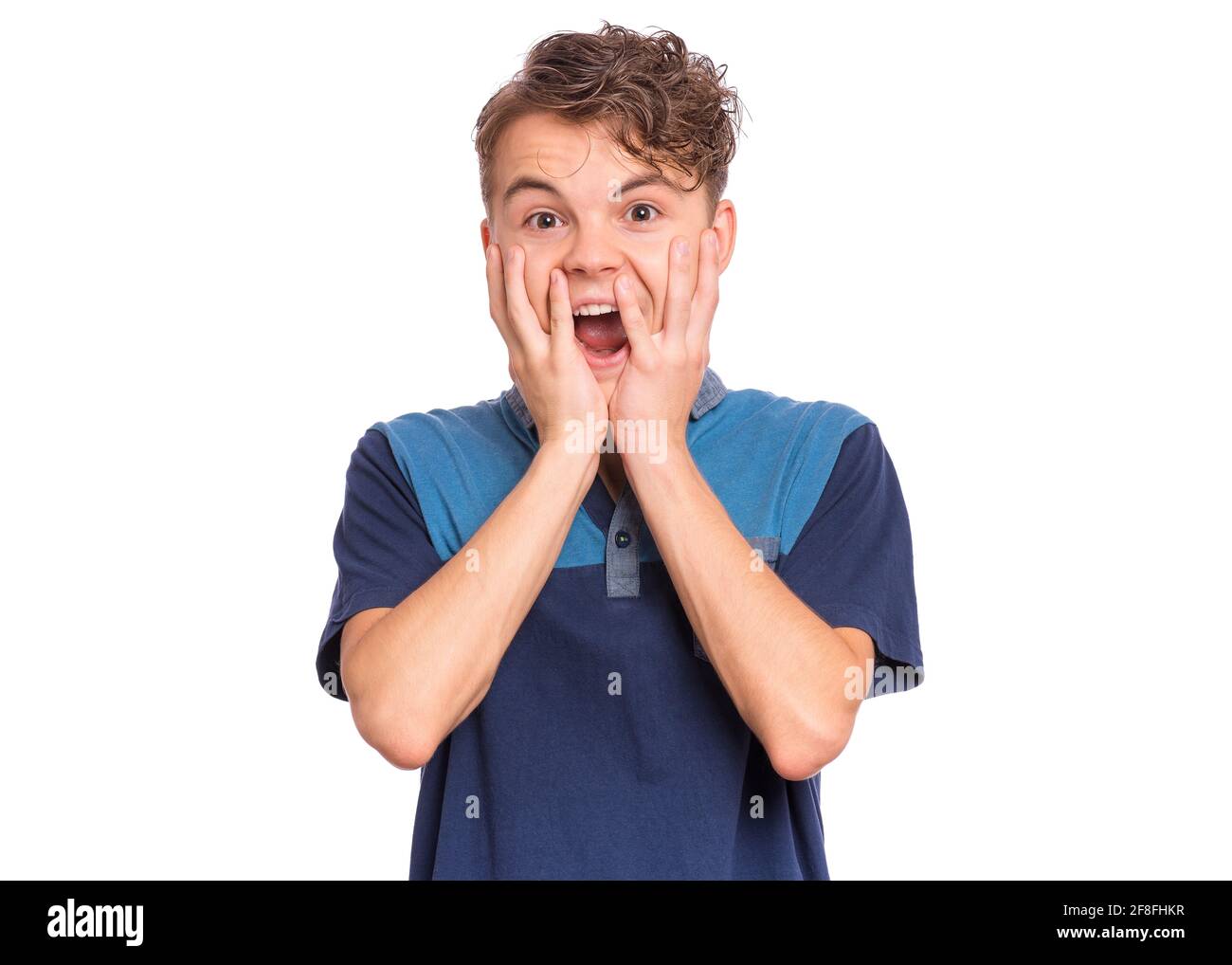 Emotional portrait of scared boy teenager, isolated on white background ...