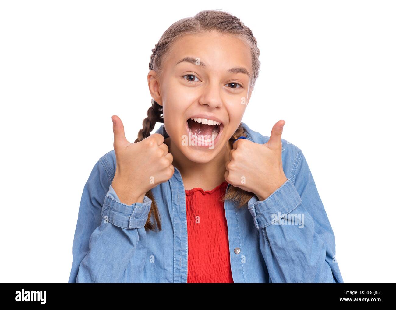 Happy teenage girl pointing up, gesturing idea or doing number one ...