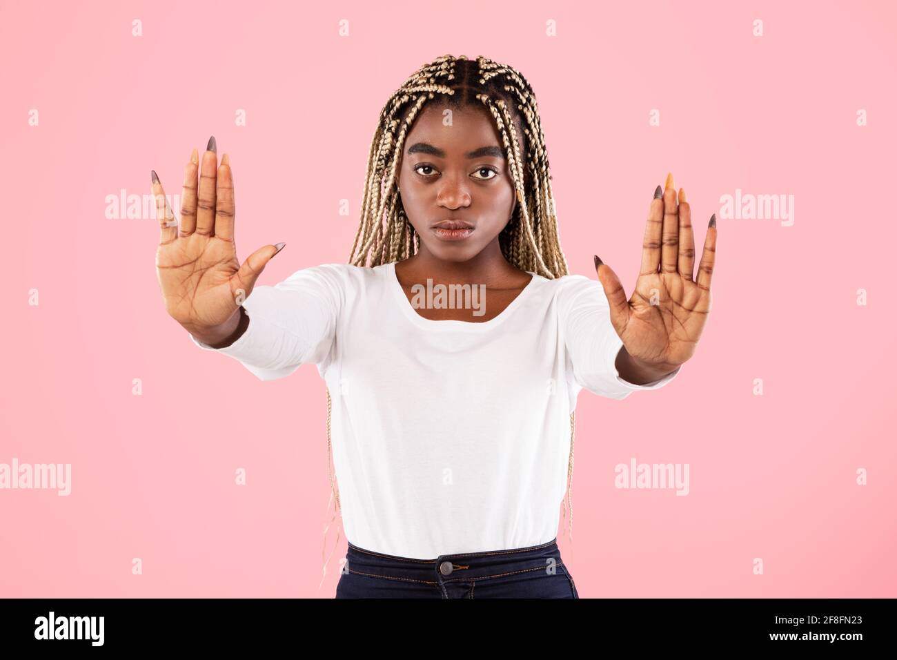 Portrait of a serious afro woman showing stop sign gesture Stock Photo ...