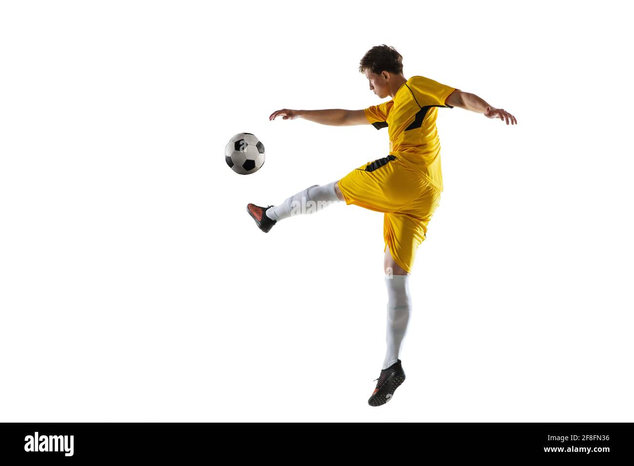 Young man, male soccer football player training isolated on white ...
