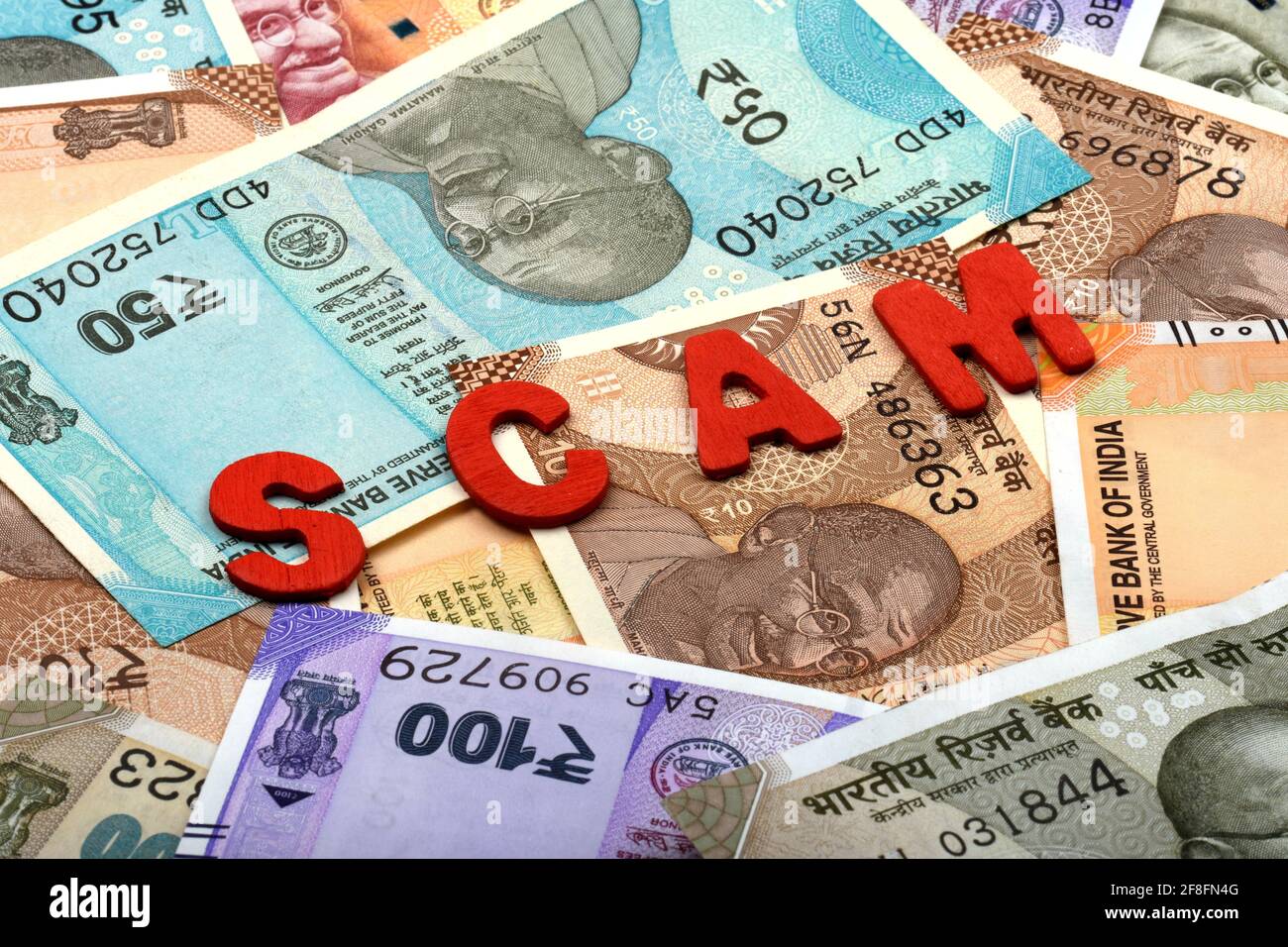 Scam and money concept, Scam red alphabets on money background, Indian ...