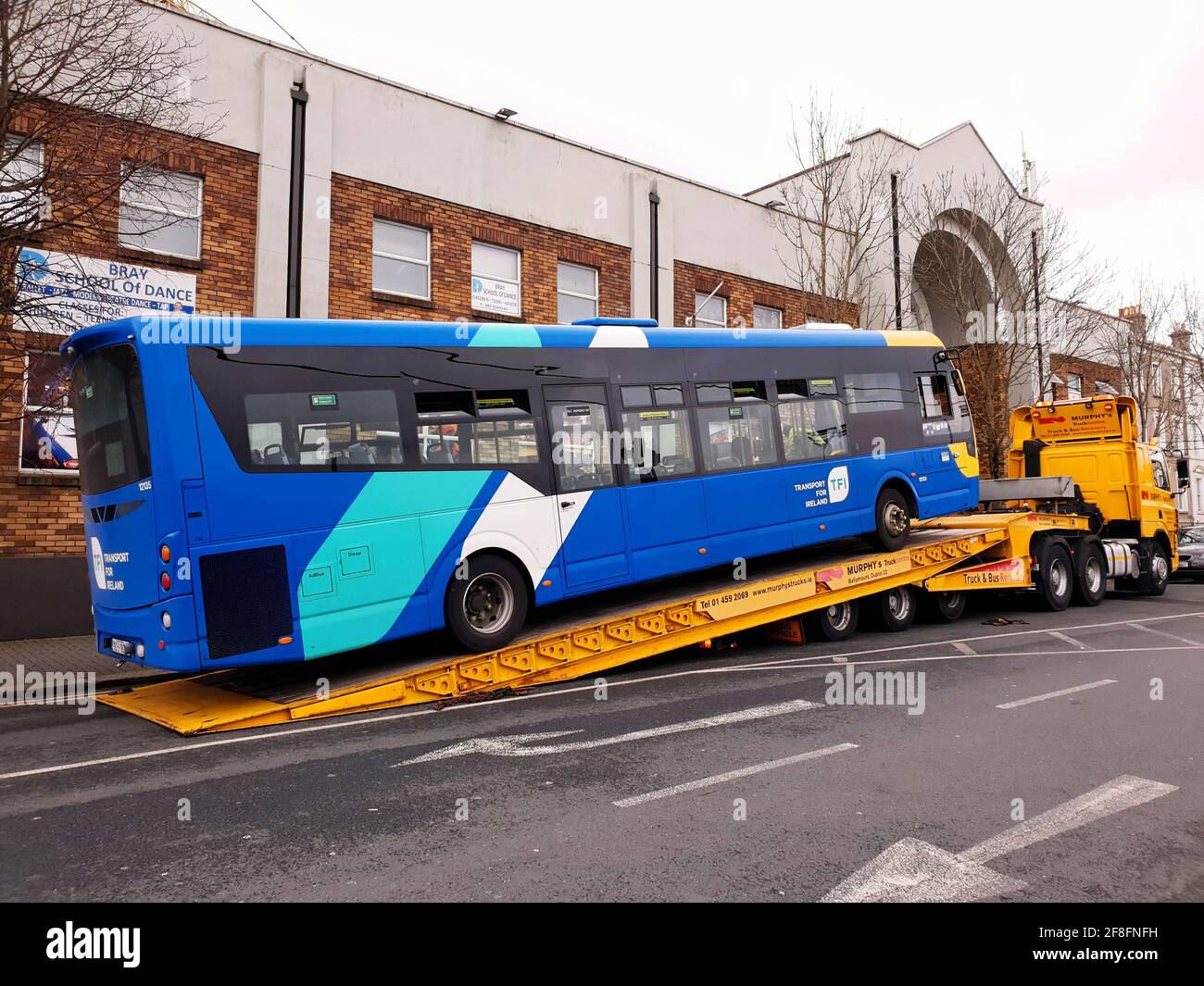 BRAY, IRELAND - Mar 15, 2021: Yellow flatbed truck with loaded broken ...