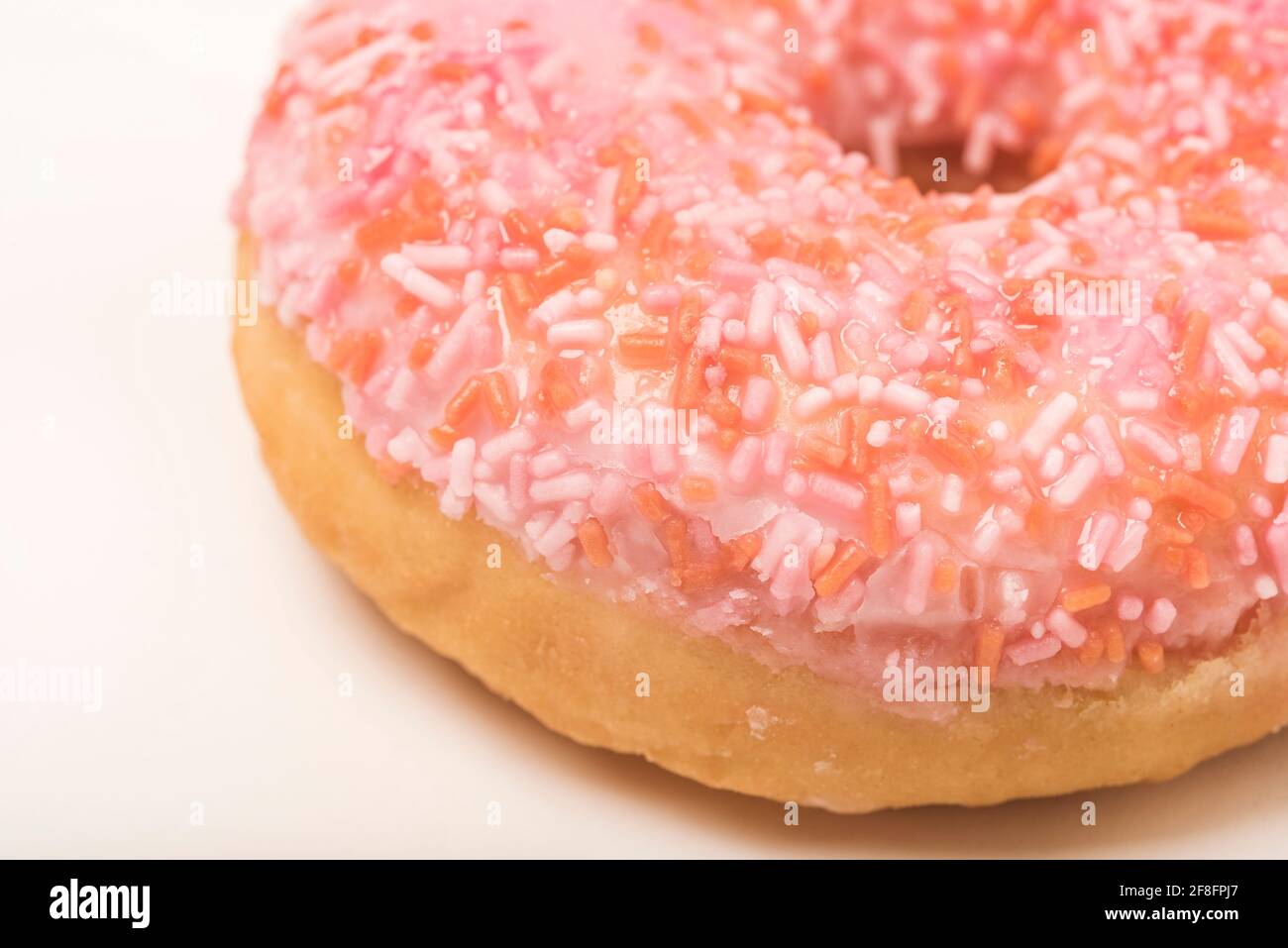 Close up of a colourful iced ring doughnut with sprinkles Stock Photo ...
