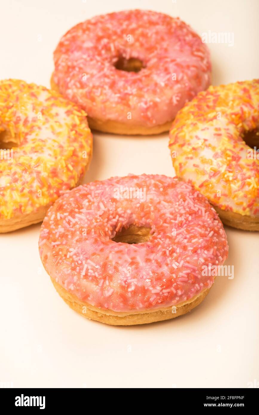 Colourful iced ring doughnuts with sprinkles Stock Photo - Alamy