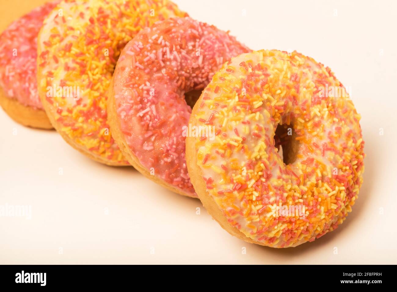 Colourful iced ring doughnuts with sprinkles Stock Photo - Alamy