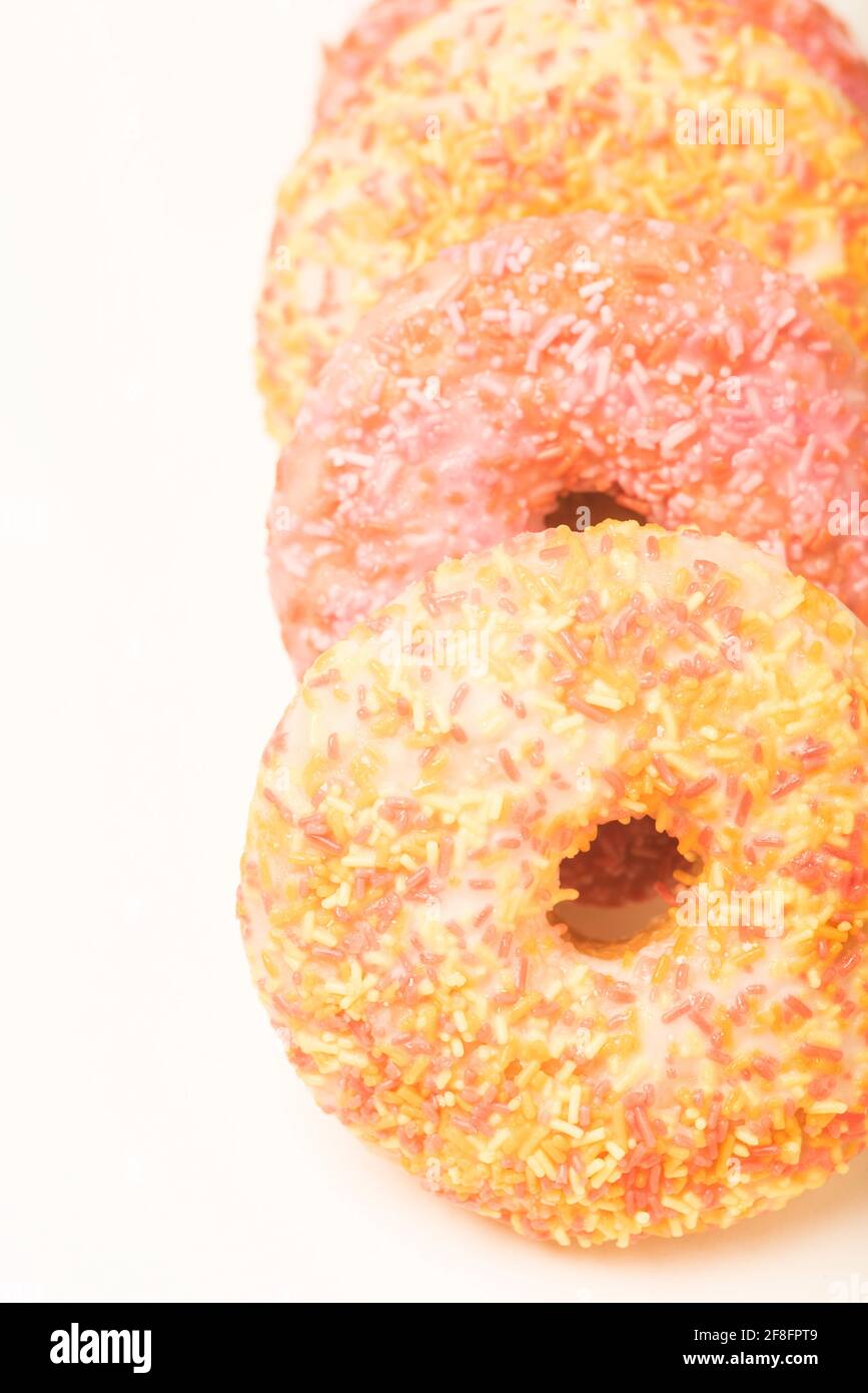 Colourful iced ring doughnuts with sprinkles Stock Photo - Alamy