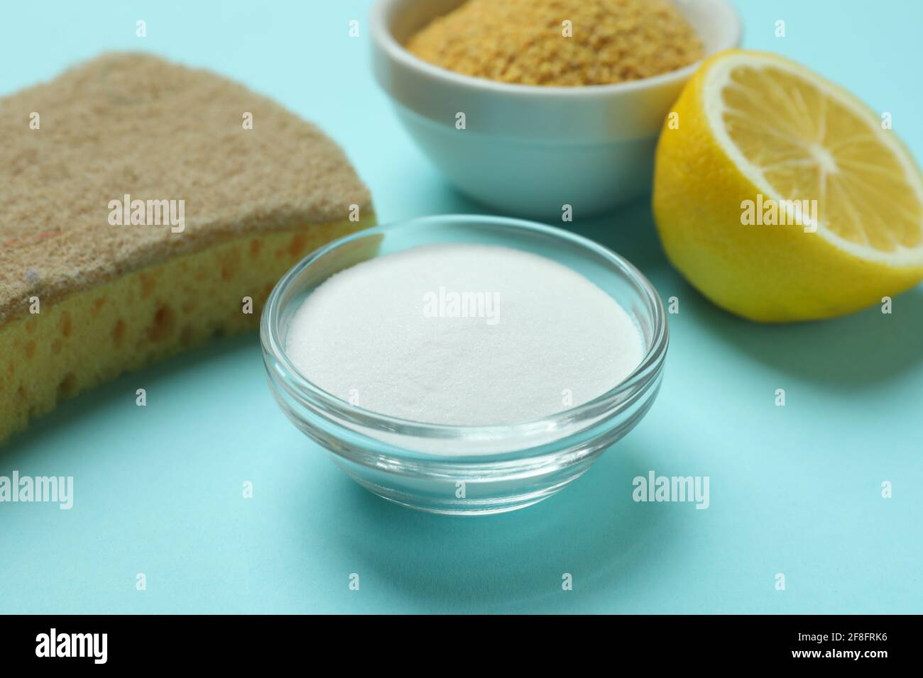 Bowls with mustard powder and acid powder, sponge and half of lemon on ...