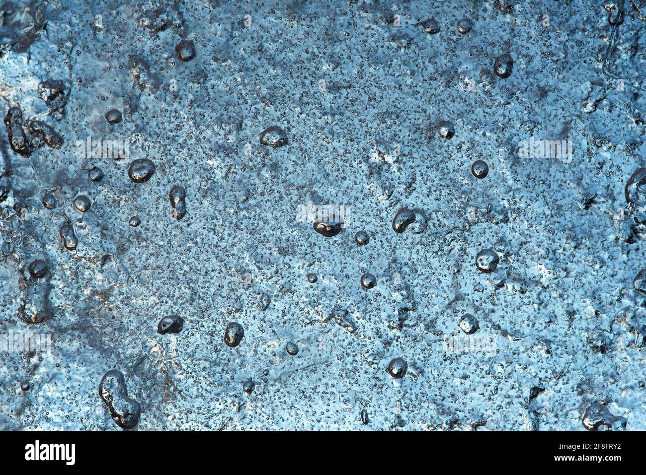Bubbles trapped in ice. Blue Stock Photo - Alamy