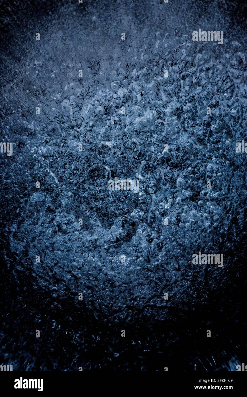 Bubbles trapped in ice. Blue Stock Photo - Alamy