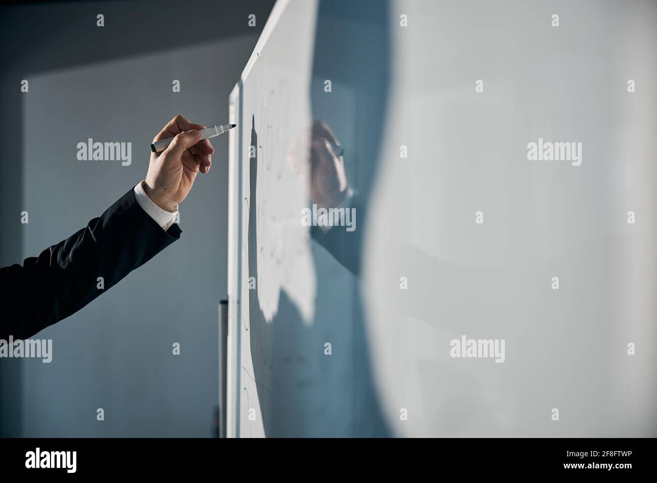 Male hand writing on whiteboard in office Stock Photo - Alamy